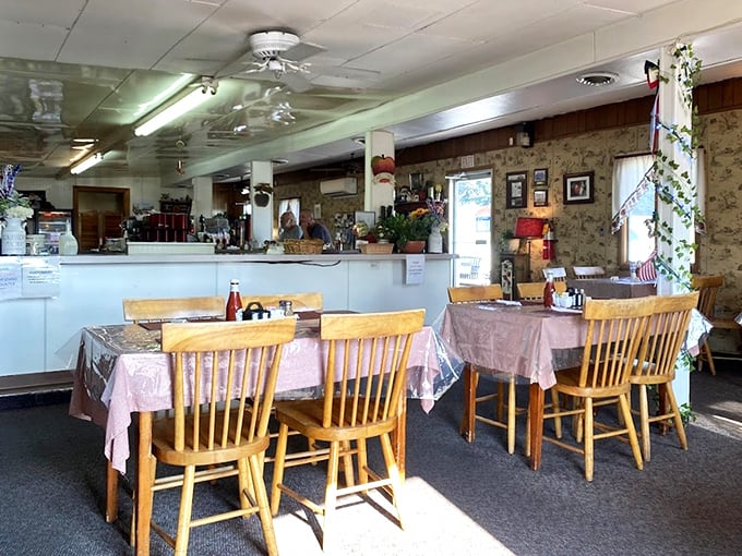 Pink tablecloths, wooden chairs, and homey decor create that perfect small-town diner atmosphere where conversations flow as freely as the coffee.
