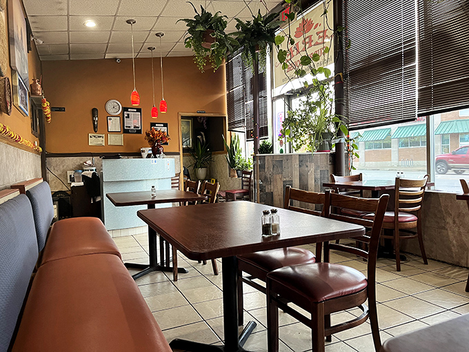 Inside, hanging plants and warm earth tones create an inviting atmosphere that says, "Forget the fancy frills, we're here for the food."