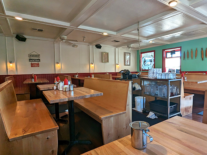 Wooden booths worn to perfection by decades of happy diners. That turquoise accent wall isn't just pretty&mdash;it's practically announcing "memorable meal ahead!"