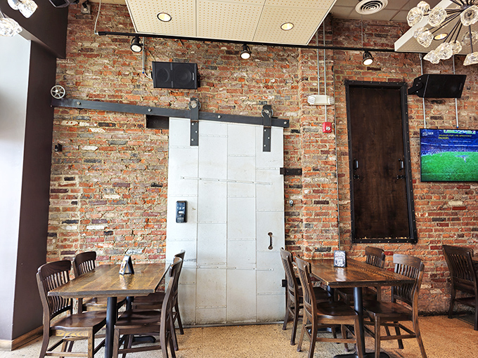 Exposed brick walls and rustic wooden tables create that perfect "I've discovered something special" atmosphere. That sliding barn door isn't just for show&mdash;it's a portal to flavor town.