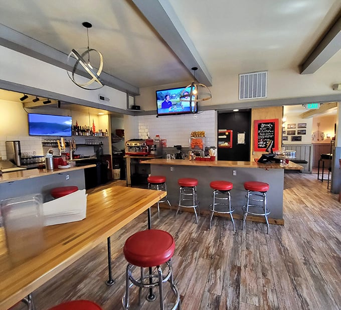 Red bar stools and warm wood tones create that perfect mountain-modern vibe where conversations flow as easily as the local craft beers.