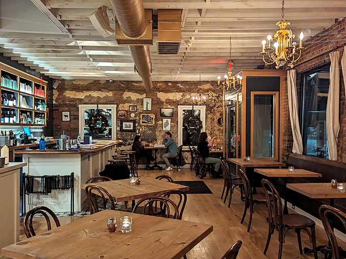Exposed brick walls and vintage chandeliers create the perfect rustic-chic atmosphere where every table feels like the best seat in the house.