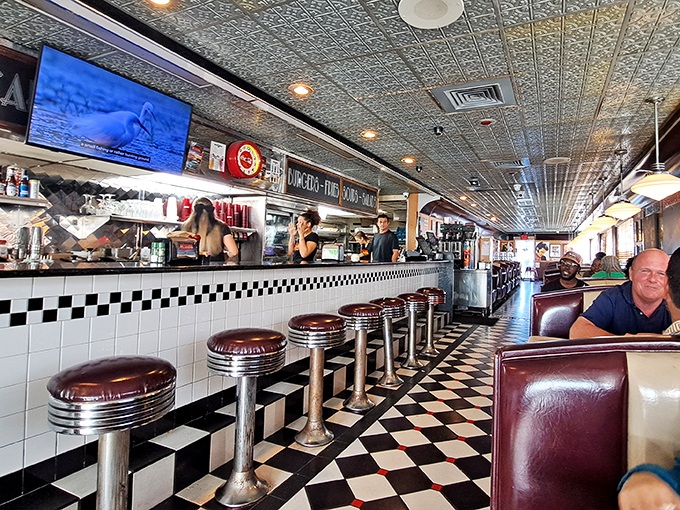 Classic black and white checkered floors meet cherry-red counter stools&mdash;this isn't retro cosplay, folks, it's the real nostalgic deal.