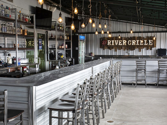 Industrial-chic meets warm hospitality at the bar. Those pendant lights aren't just illuminating the space—they're spotlighting your next great meal.