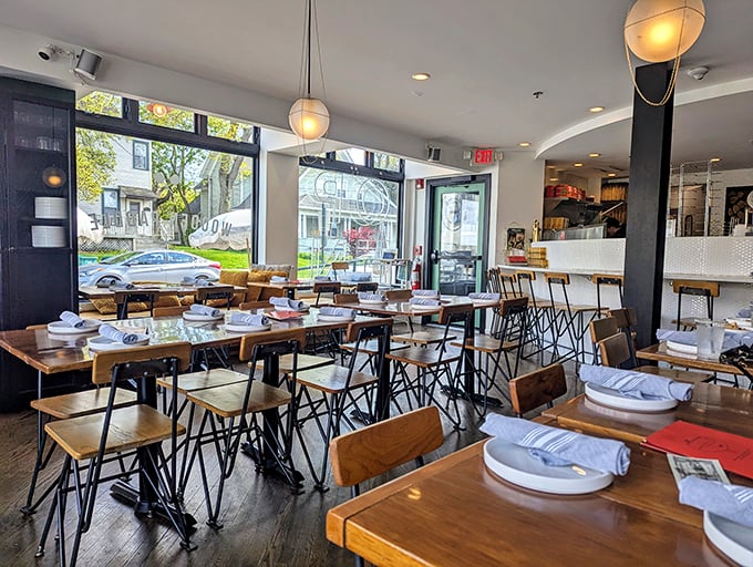 Modern meets rustic in this bright, airy dining space where wooden tables invite you to linger over one more slice.