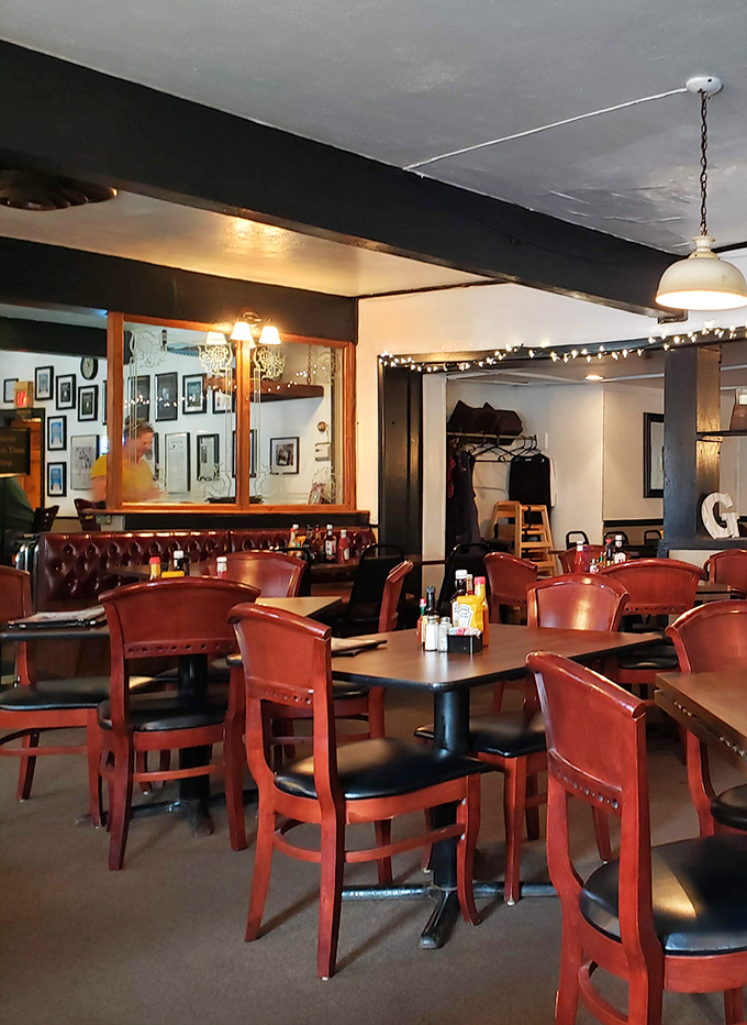 Classic red leather booths and warm lighting create the perfect atmosphere for serious comfort food conversations.