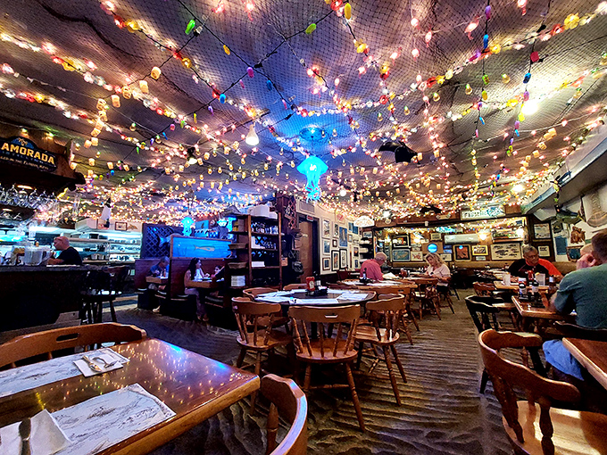 Christmas lights meet fishing nets on the ceiling, creating a twinkling underwater wonderland that makes every meal feel like a special occasion.