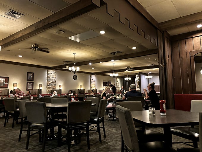 Step into the warm embrace of wood paneling, stone accents, and red booths that whisper, "The 1970s called&mdash;they want you to enjoy an excellent steak while you're visiting."