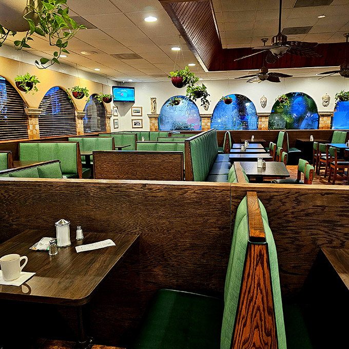 Mint-green booths and hanging plants create that perfect retro-cool vibe where every table feels like the best seat in the house.