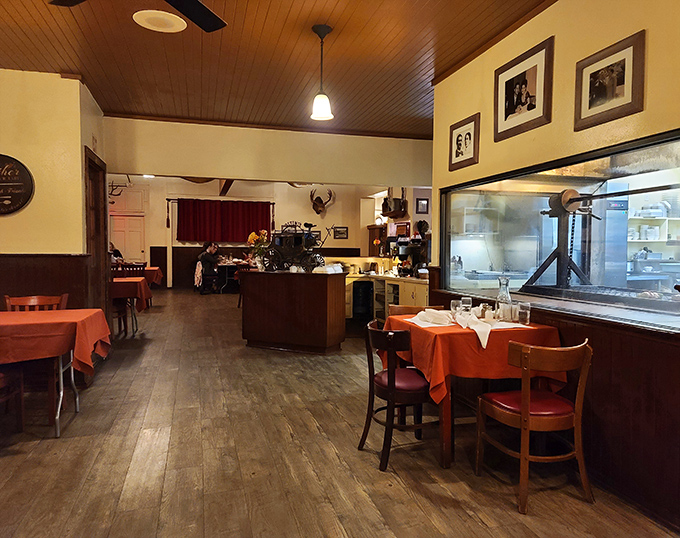 Step inside and you're transported to a simpler time&mdash;wooden paneling, red tablecloths, and the promise of oak-fired perfection.
