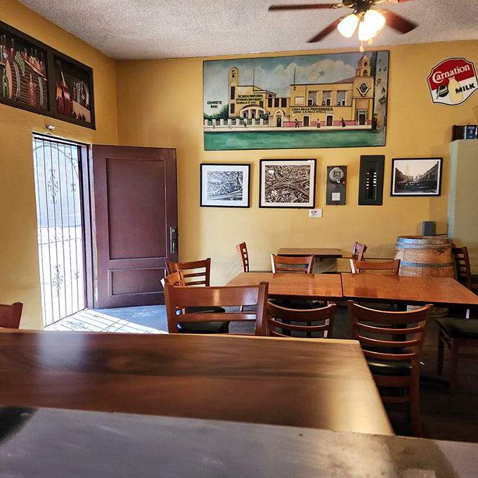 Yellow walls adorned with vintage photographs create the perfect backdrop for culinary memories. This isn't d&eacute;cor&mdash;it's a family album you're invited to join.