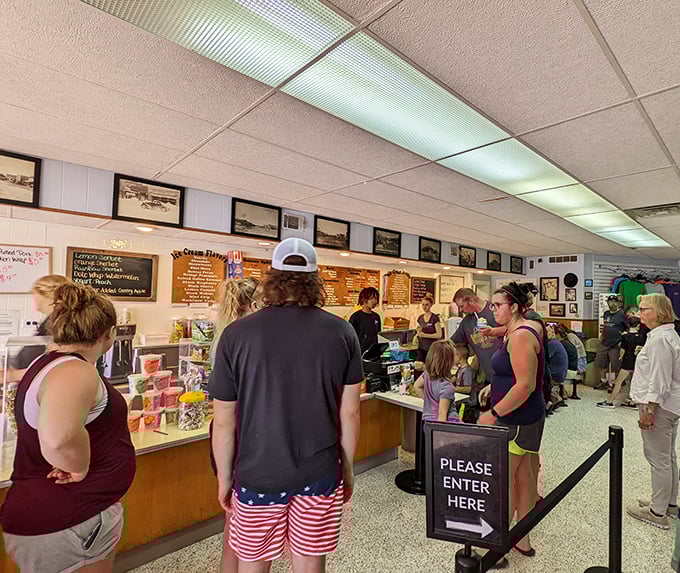 Inside, the line of eager ice cream pilgrims moves with surprising efficiency. The anticipation in the air is thicker than their hot fudge sauce.