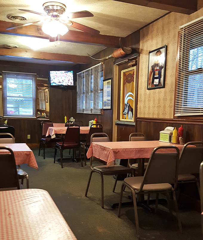 Red checkered tablecloths and wood-paneled walls create that perfect time capsule atmosphere where calories don't count and conversations flow as freely as the coffee.