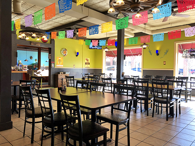 Vibrant papel picado banners dance overhead in a kaleidoscope of colors, transforming an ordinary ceiling into a perpetual fiesta.