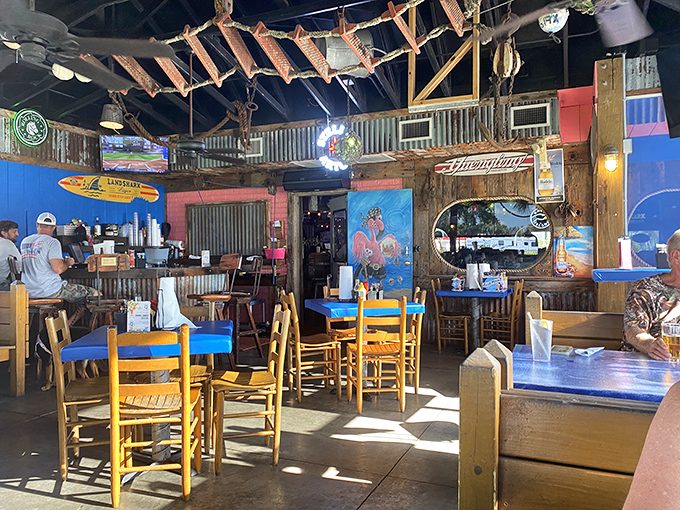 Sunshine streams through windows illuminating the perfect beach shack interior&mdash;corrugated metal meets weathered wood in a marriage of coastal charm.