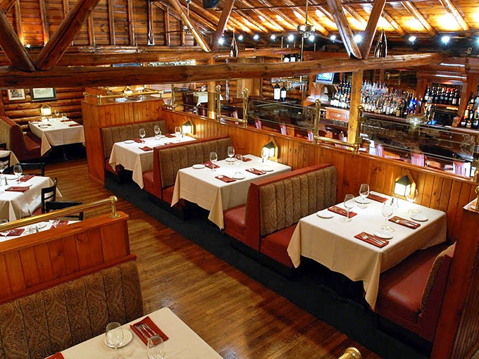 White tablecloths meet rustic wood beams in this dining room that feels like the world's most sophisticated treehouse. Elegance without pretension is the secret ingredient here.