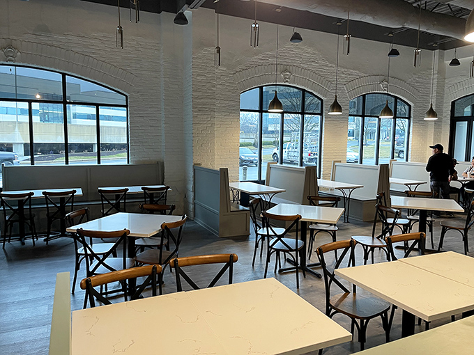 Clean lines, white brick walls, and abundant natural light create the perfect canvas for breakfast masterpieces to take center stage.