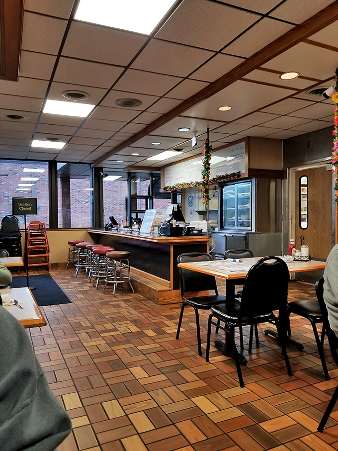 Classic diner aesthetics with wooden floor tiles and counter seating &ndash; where conversations flow as freely as the coffee refills.