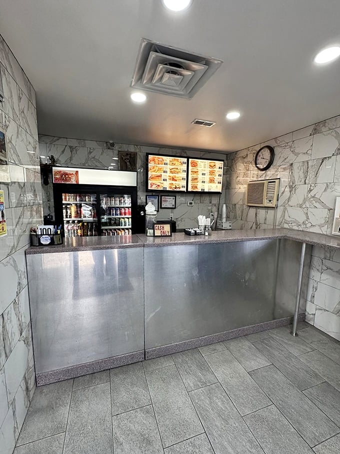 Inside, marble-patterned walls and stainless steel counters create a no-nonsense atmosphere where the food does all the talking.