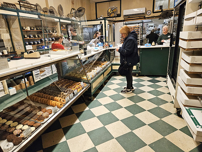Inside, the classic checkerboard floor and glass display cases create a time capsule where calories don't count and decisions become deliciously difficult.