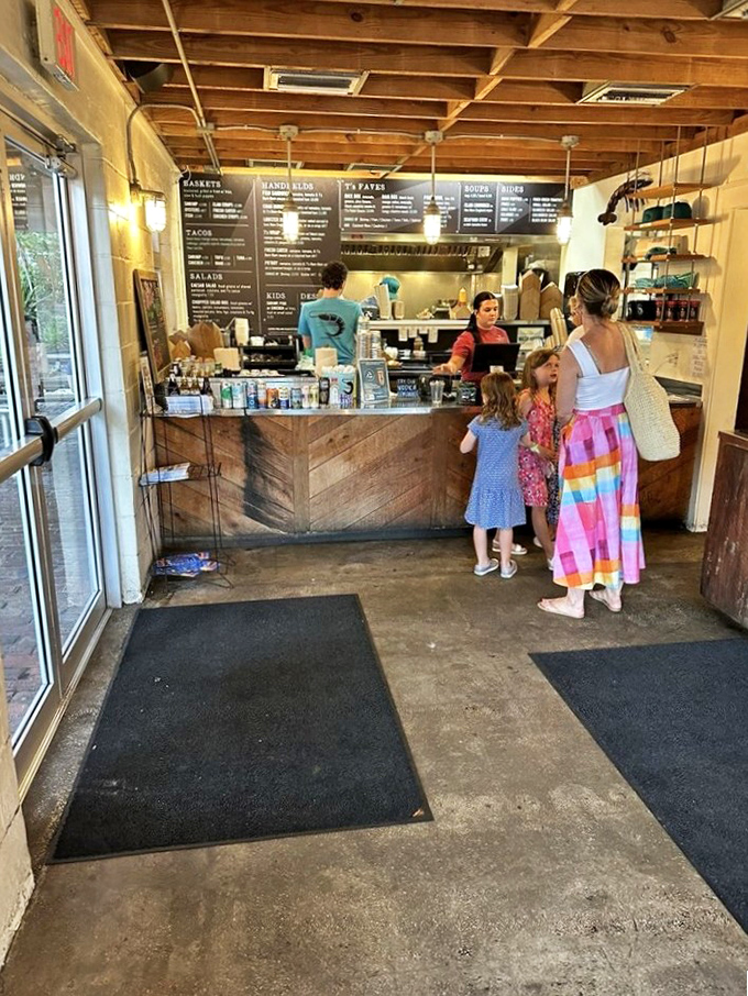 Step inside to rustic wooden beams and a no-nonsense counter where life-changing seafood decisions await. The menu board looms like a delicious choose-your-own-adventure novel.