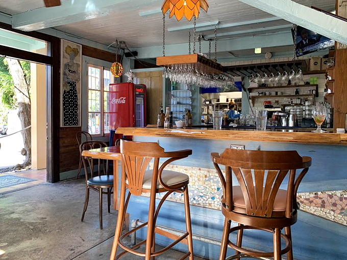 Step inside this wonderfully weathered interior where vintage Coca-Cola machines and mismatched charm create the perfect backdrop for extraordinary comfort food.
