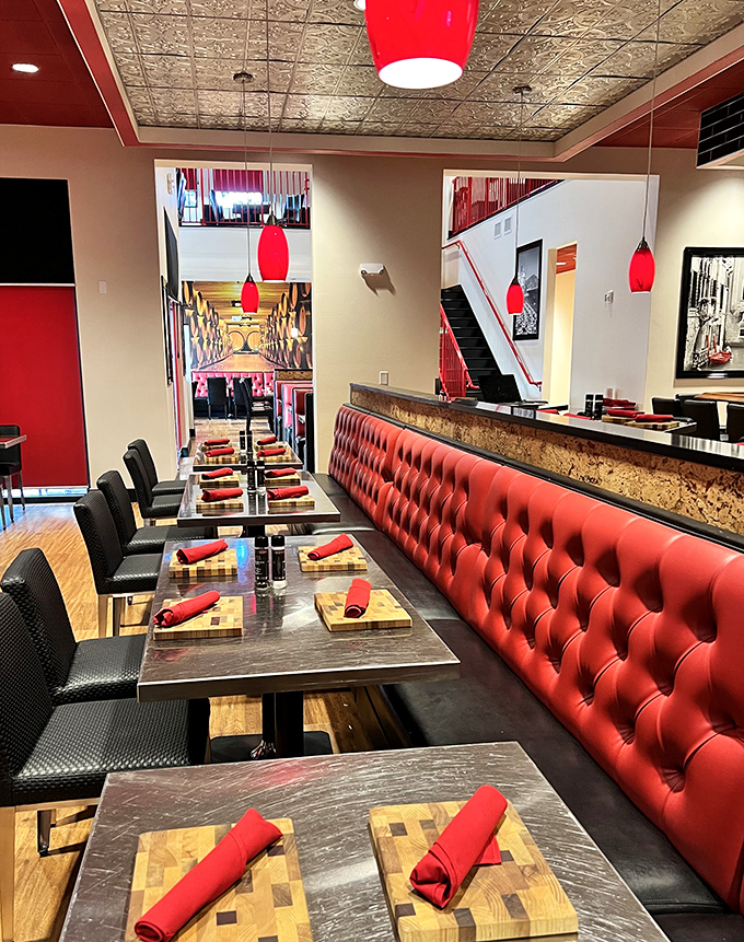 Red tufted banquettes and sleek tables create a dining atmosphere that says, "Yes, we're fancy, but we won't judge if you lick your plate."