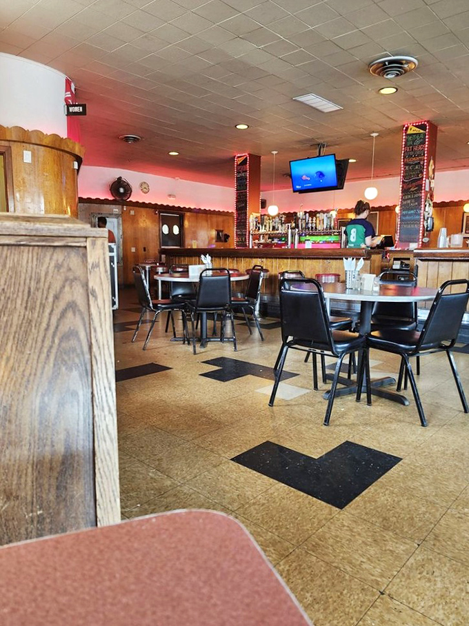 Step inside and you're transported to a cozy time capsule with checkerboard floors and wood paneling that feels like your favorite uncle's basement—if he served amazing hot dogs.