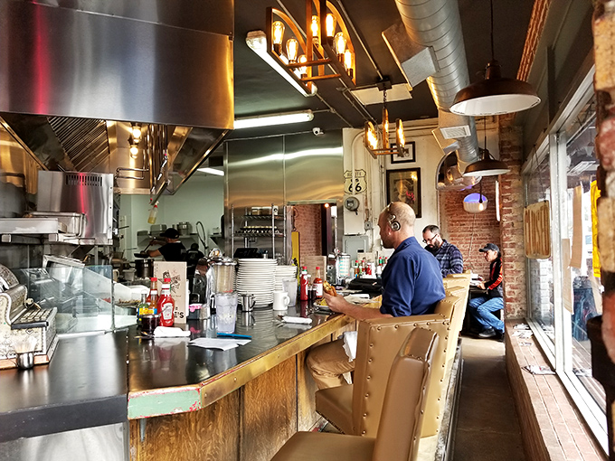 The counter seats offer front-row tickets to the breakfast ballet. Watch skilled cooks transform simple ingredients into morning masterpieces while exposed brick adds warmth.