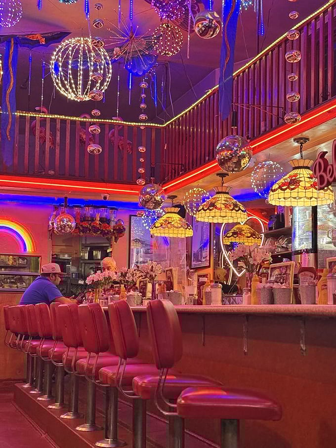 As night falls, Orphan Andy's neon glow transforms into a beacon for comfort food seekers, a 24-hour oasis in San Francisco's colorful Castro neighborhood.