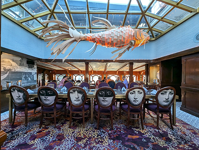 Dining under a sculptural fish mobile while surrounded by chairs featuring artistic faces&mdash;this isn't your average seafood joint, it's maritime theater.