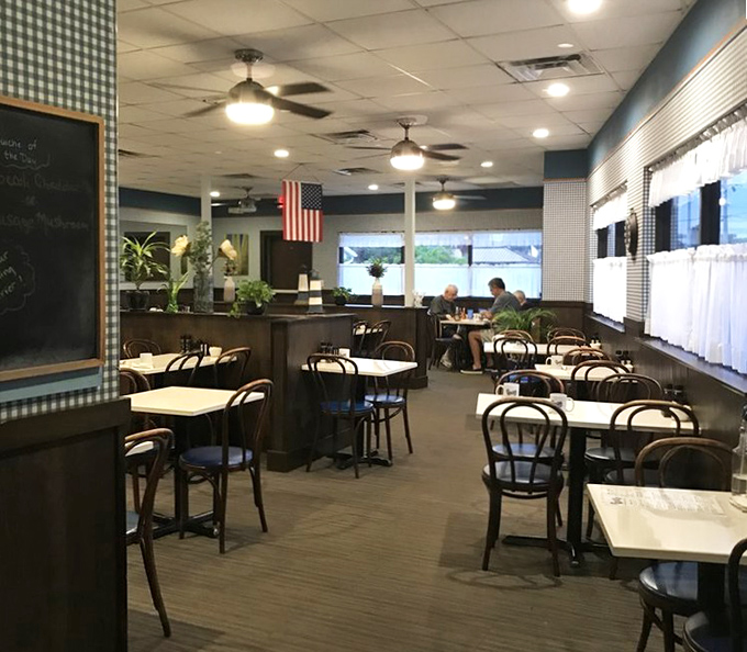 Classic diner charm with blue checkered walls and wooden chairs. The kind of place where breakfast decisions become life's most important choices.