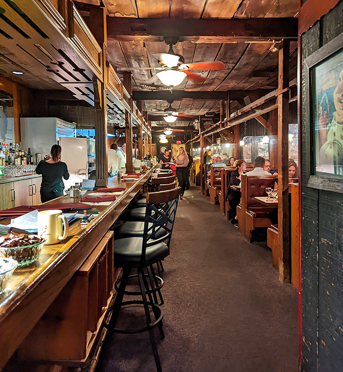 Step inside and you're transported to a world where wood-paneled warmth meets maritime charm. The narrow dining room feels like the cozy galley of a well-loved ship.