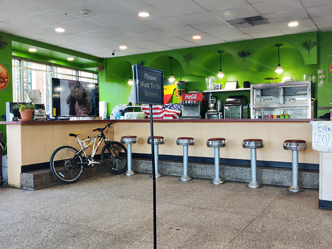 Those vibrant green walls aren't just a design choice—they're a warning sign that something extraordinarily fresh is happening inside. Classic counter seating invites conversation and seafood revelations.