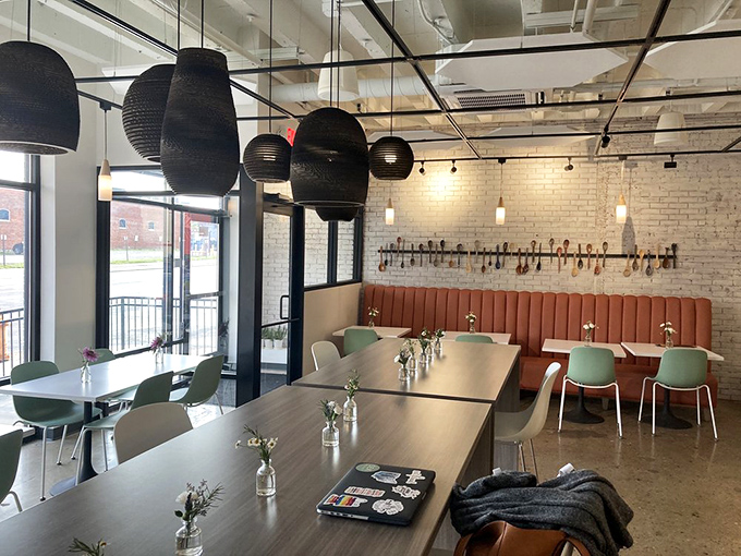 Modern meets cozy in this thoughtfully designed space where woven pendant lights cast a warm glow over conversations waiting to happen.