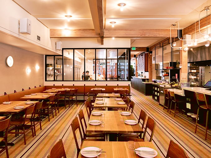 Warm wooden tables, exposed beams, and that perfect neighborhood restaurant glow. The kind of place where memories are made between bites.