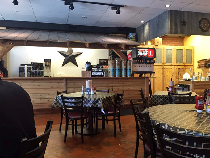 Inside, rustic charm meets BBQ business. That star on the wall isn't just decoration – it's practically a sheriff's badge in the wild west of smoked meats.