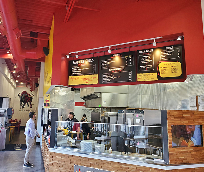 Step inside where red walls and open kitchens create the perfect stage for barbecue theater magic.