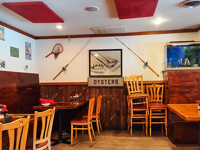 Fishing rods and nautical decor transform this cozy dining room into a sea captain's quarters. The "OYSTERS" sign isn't just decoration&mdash;it's a delicious promise.