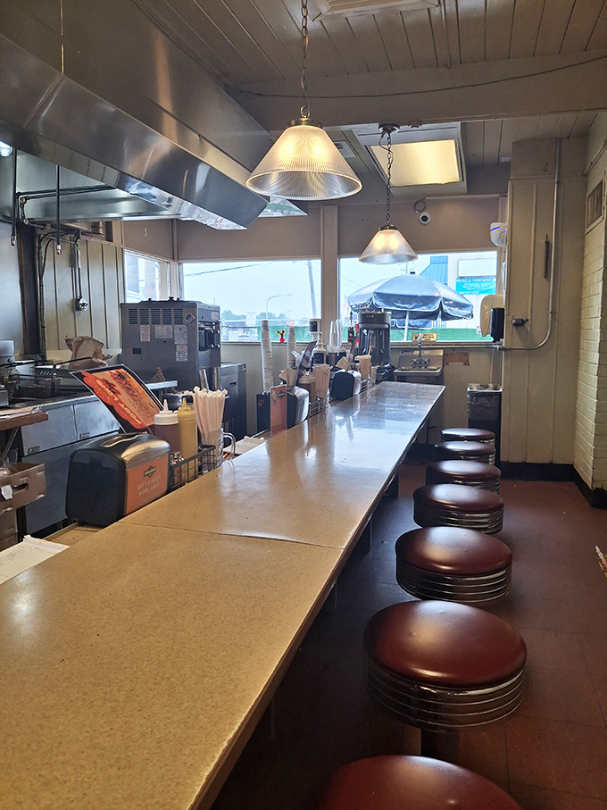 Classic black and white checkered floors meet vintage ceiling tiles in this dining room that feels both nostalgic and perfectly modern.