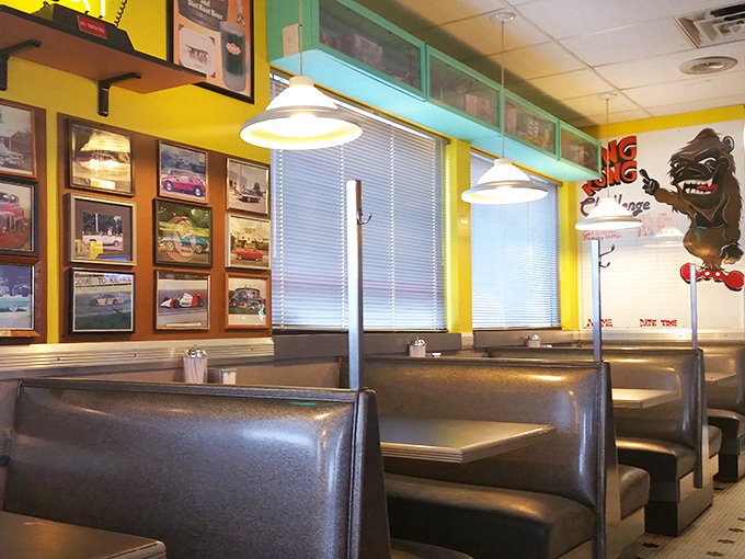Silver booths gleam beneath vintage car photos, creating the perfect backdrop for conversations about first cars, first dates, and first-rate comfort food.