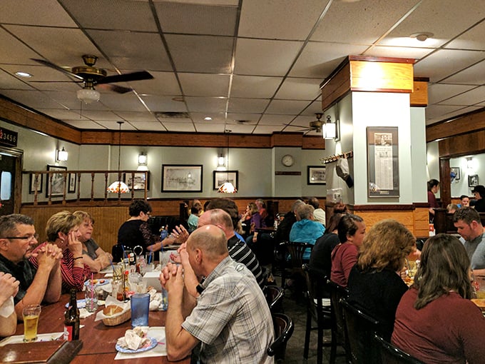 Friday night at Hickory Bar-B-Q looks like a family reunion where everyone actually likes each other. The wood paneling isn't retro&mdash;it's authentic. 