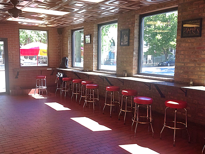 Red stools lined up like soldiers, ready to witness some serious sandwich demolition.