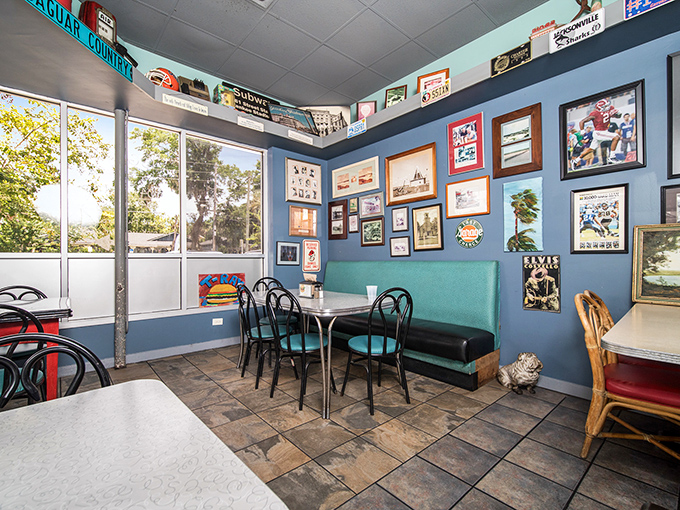Blue walls adorned with decades of memories create the perfect backdrop for life-changing burger experiences. No interior designer needed, just authentic charm.