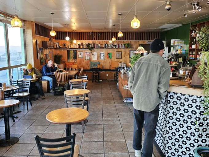 Inside, warm wood paneling and pendant lights create that rare atmosphere where time slows down and conversations flow as easily as the coffee.