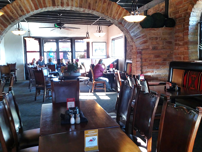 Brick archways frame culinary conversations while leather chairs invite you to settle in for the long game of serious eating.