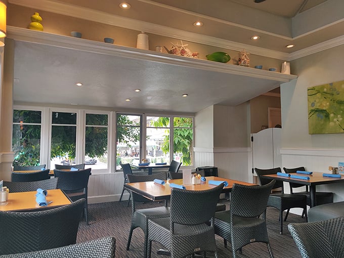 Coastal chic meets homey comfort in this light-filled dining room. Those windows don't just frame the La Jolla greenery—they invite it to be part of your meal.