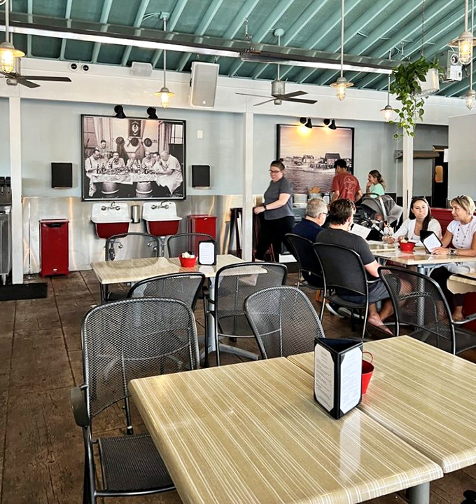 Inside, the seafoam ceiling and historic photos create a space that feels both nautical and nostalgic, like a stylish fisherman's cottage with better cocktails.