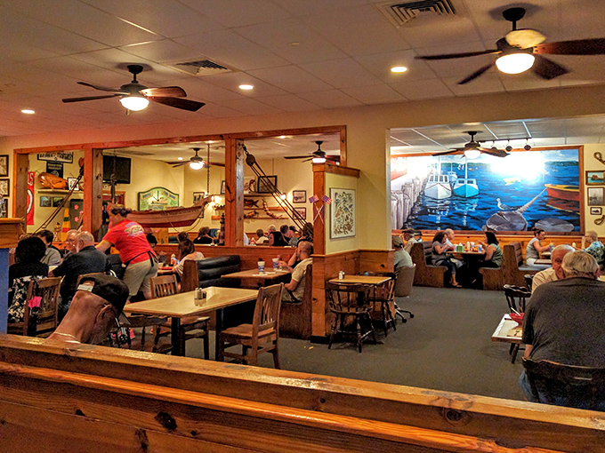 Inside, nautical charm meets New England nostalgia. The mural transports you straight to a Massachusetts harbor while ceiling fans keep the Florida reality at bay.