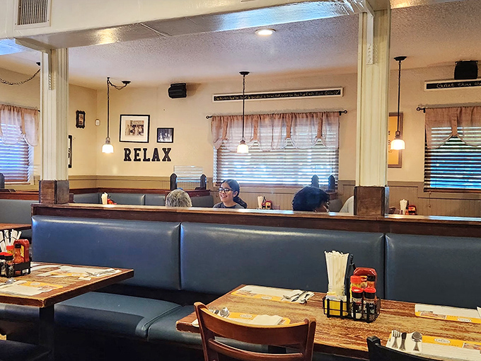 The "RELAX" sign isn't just decoration&mdash;it's a command you'll happily obey once settled into these cozy blue booths with a plate of Southern goodness.